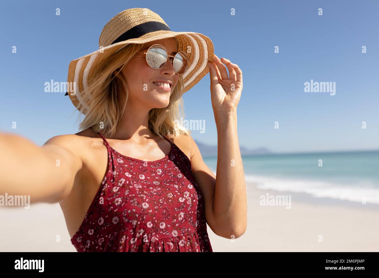 Caucasian woman standing on the beach Stock Photo - Alamy