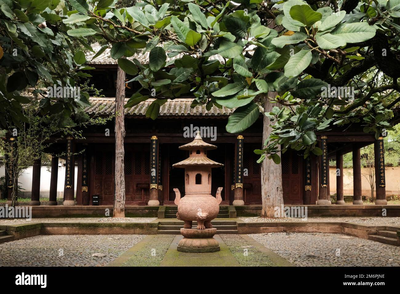Traditional buddhist temple courtyard. Old temple garden with trees ...
