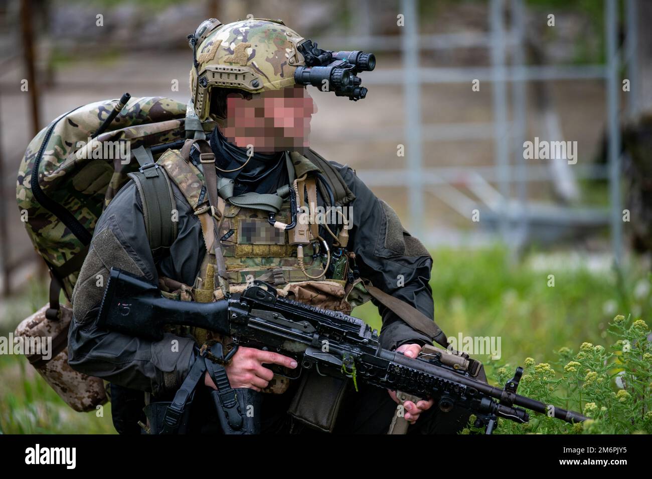 A U.S. Navy SEAL conducts a tactical pause while on patrol during ...