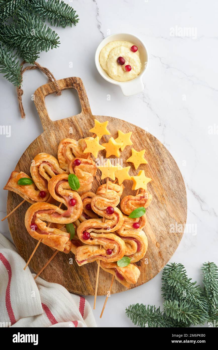 Christmas or New Year appetizer. Christmas tree shape puff pastry buns ...