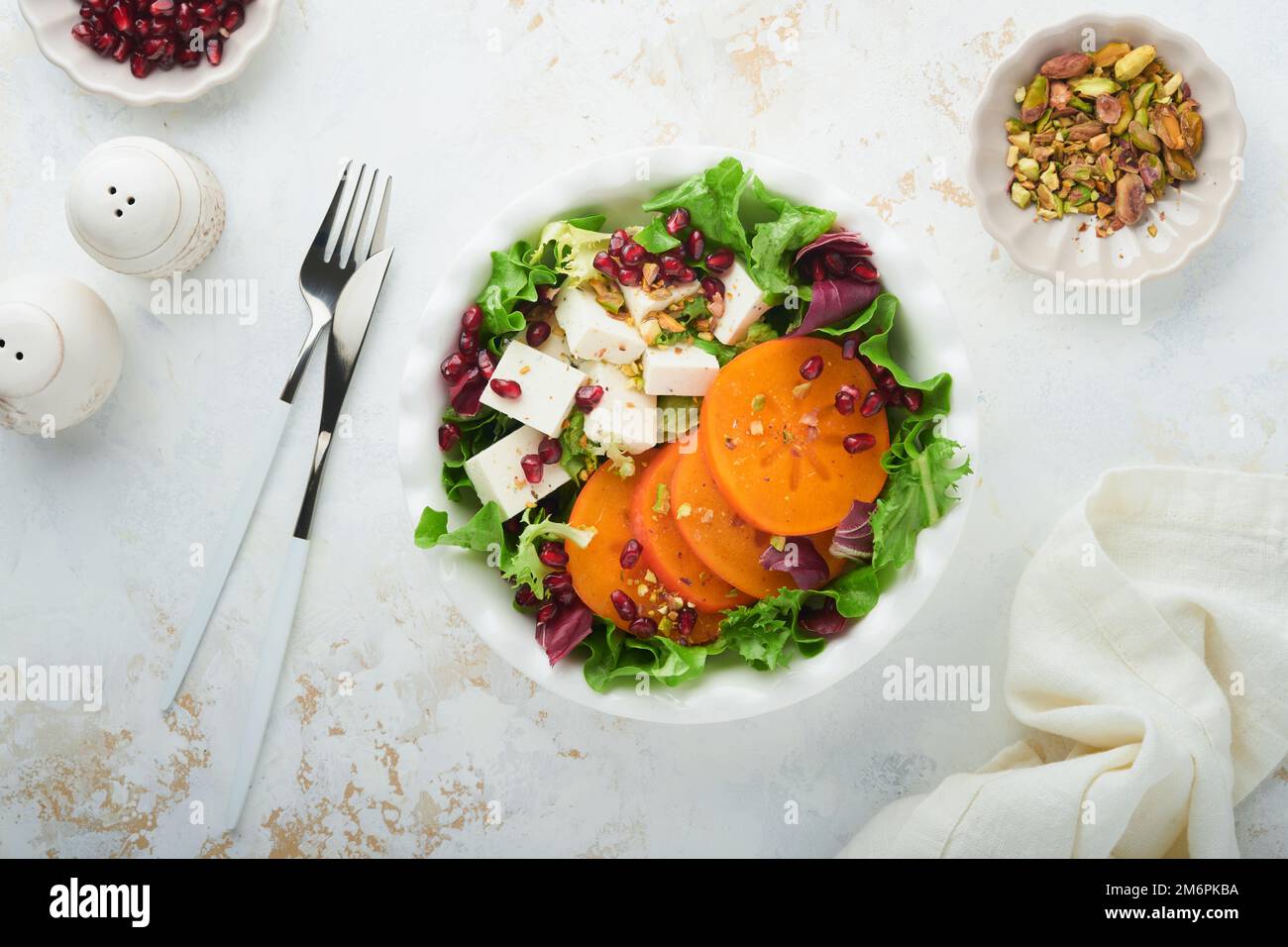 Salad. Fresh green salad with feta cheese, persimmon, pomegranate and ...