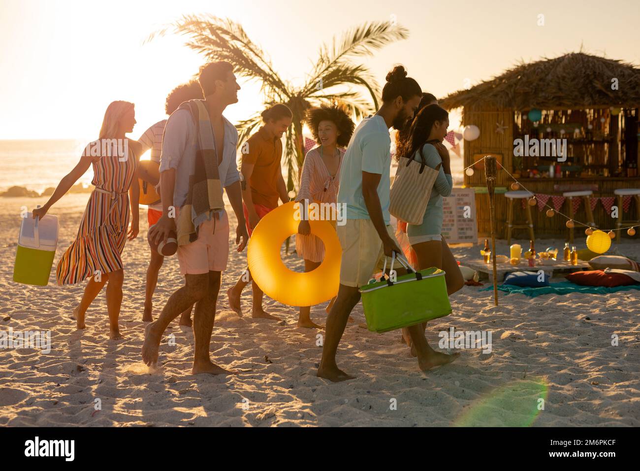 Mixed race friends group walking on beach Stock Photo - Alamy