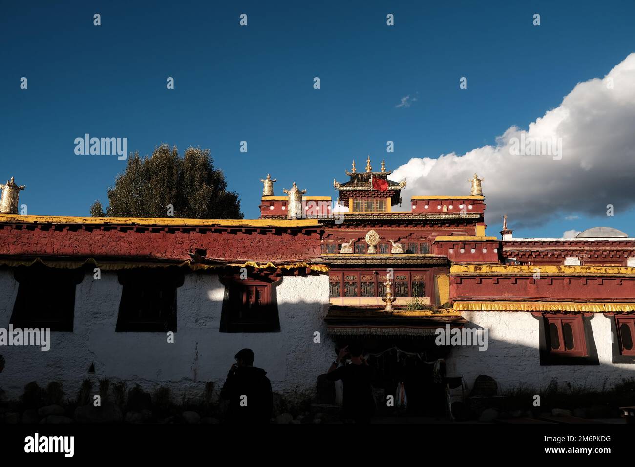 Tibetan architecture. Traditional tibetan house in the sunlight and blue sky with clouds ...