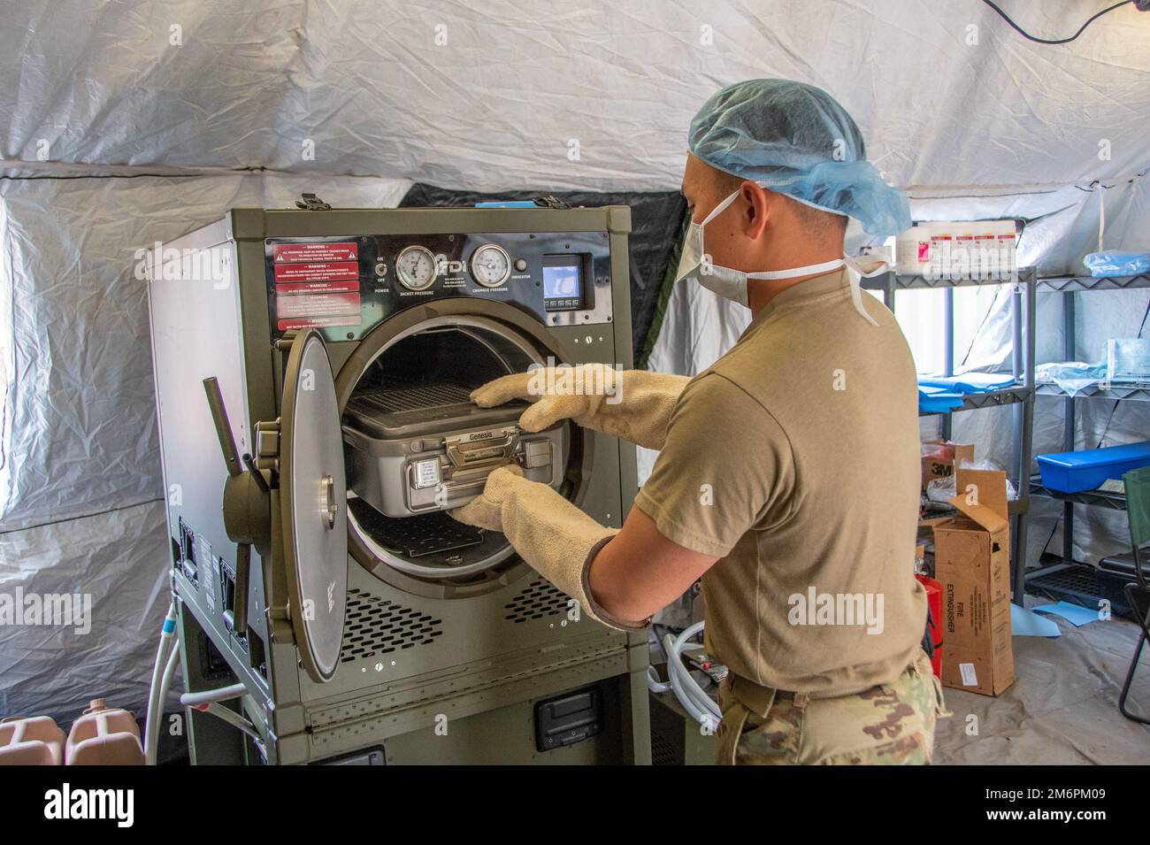 U.S. Army Soldier assigned to the 512th Field Hospital sterilizing ...