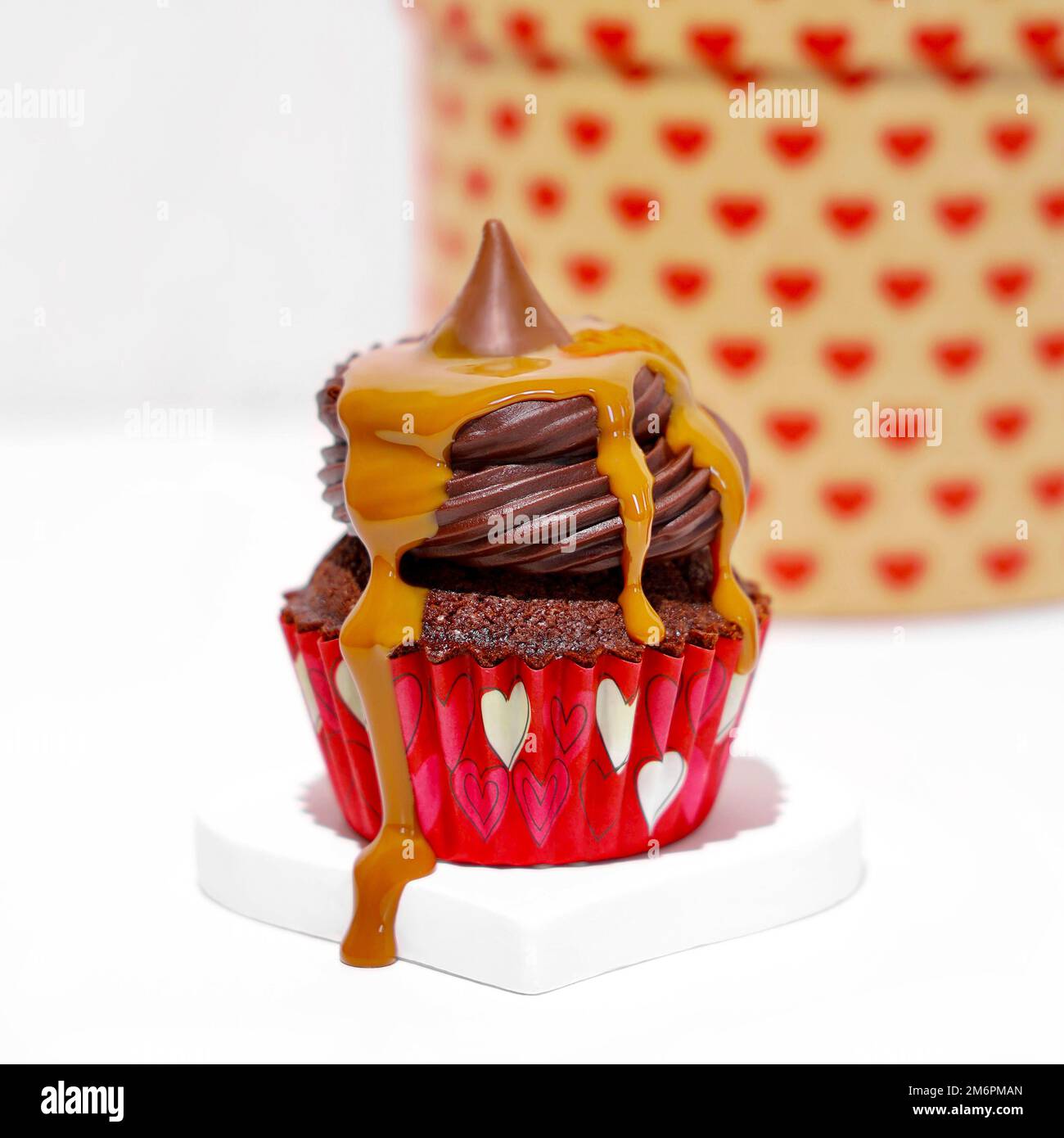 Chocolate cupcake with toffee sauce on white background Stock Photo - Alamy