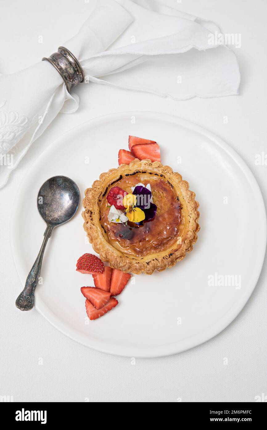 Custard toffee tart with berries Stock Photo - Alamy