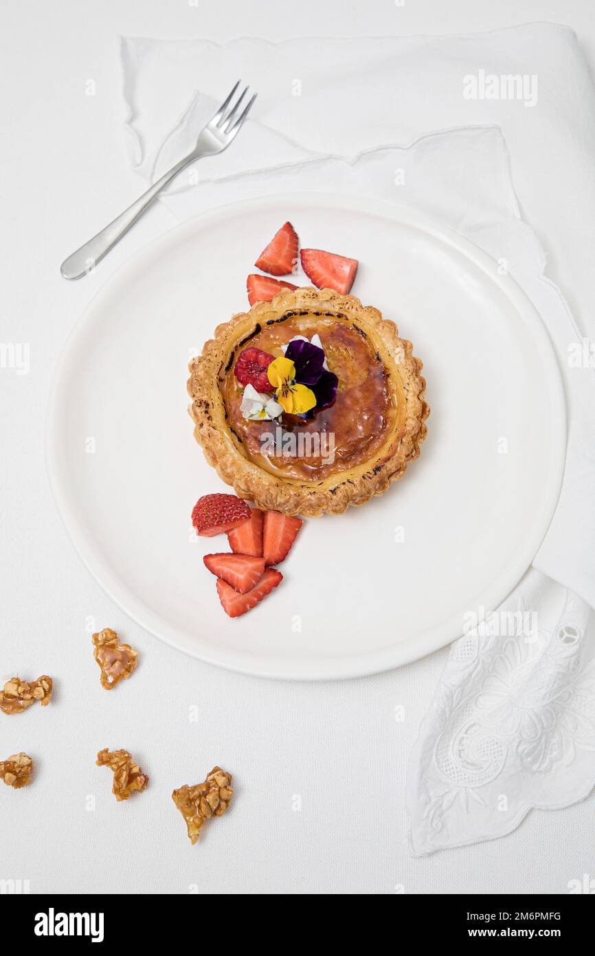 Custard toffee tart with berries Stock Photo - Alamy
