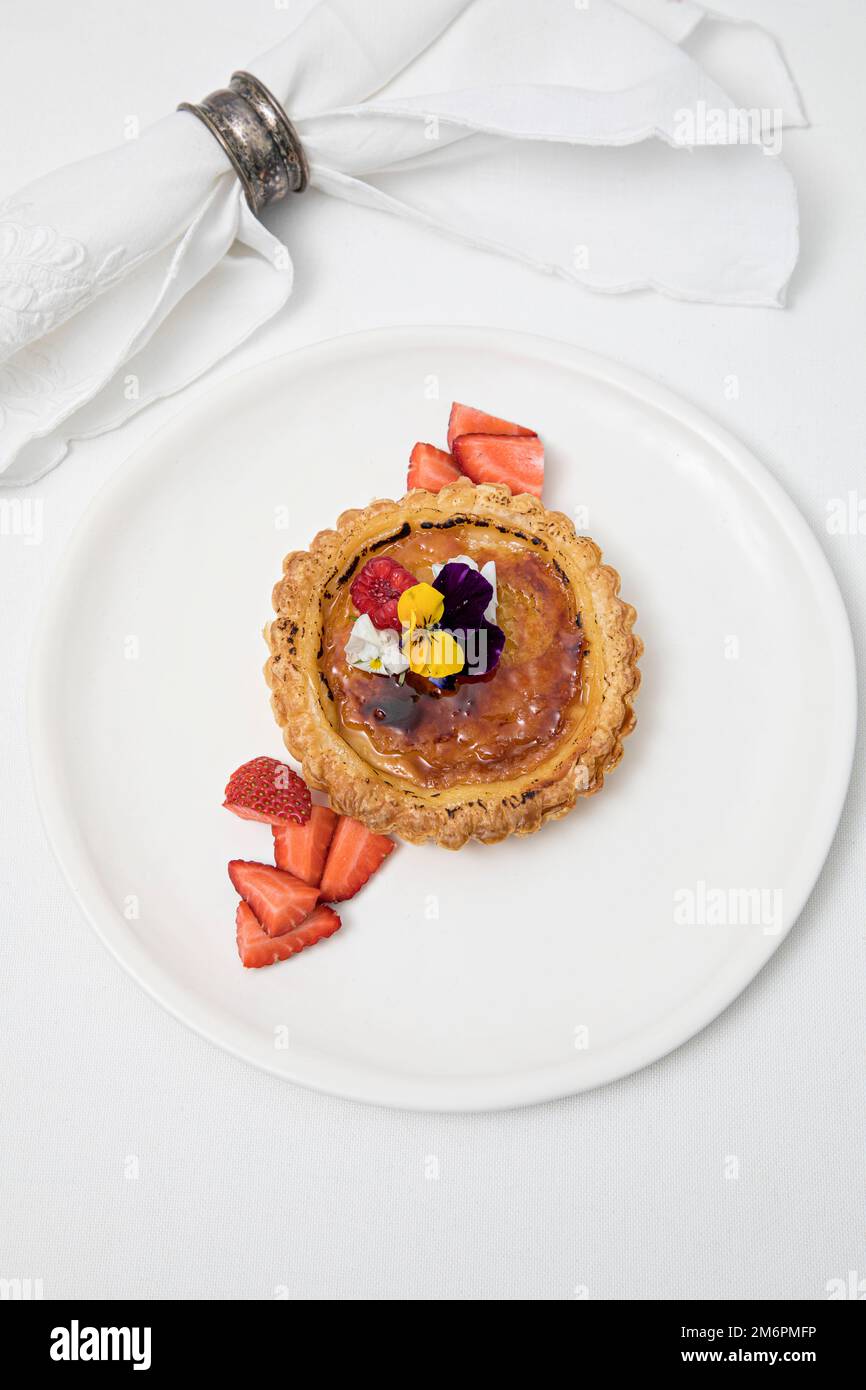 Custard toffee tart with berries Stock Photo - Alamy