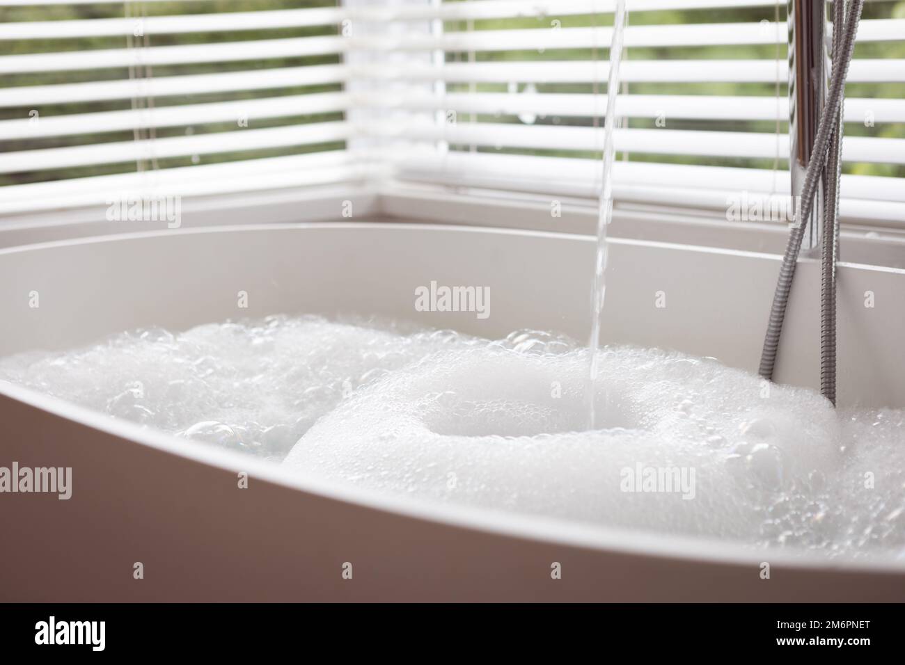Running water in modern Bathtub Stock Photo - Alamy