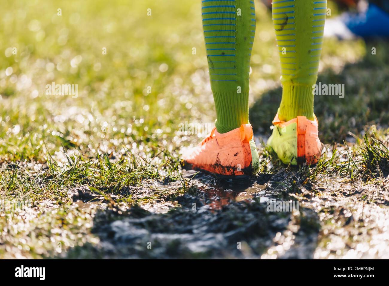 Legs of Soccer Player Standing in Muddy Grass Pitch. Football Clothes ...