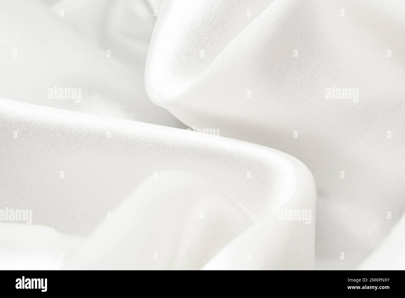 The texture of a fabric made of silk or calico with waves and rumples ...