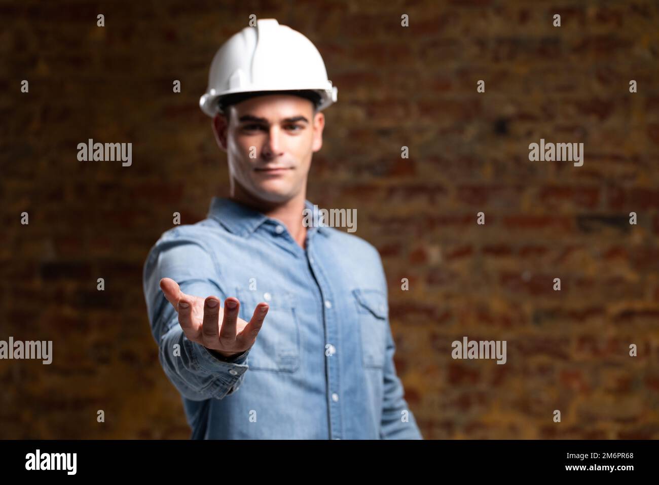 Engineer looking camera touching helmet hi-res stock photography and ...