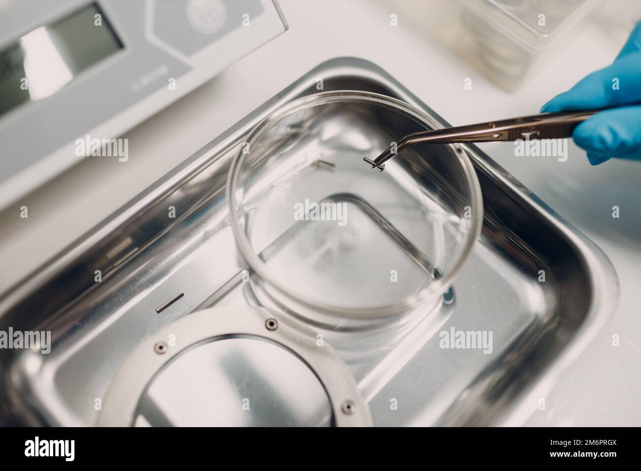 Young woman doing ear piercing at beauty studio salon Stock Photo - Alamy
