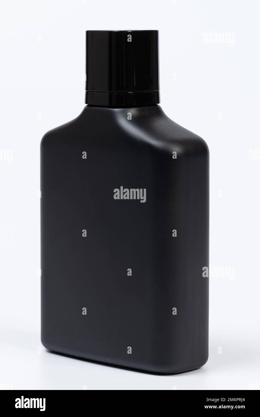 Black perfume spray bottle side view isolated on studio background ...