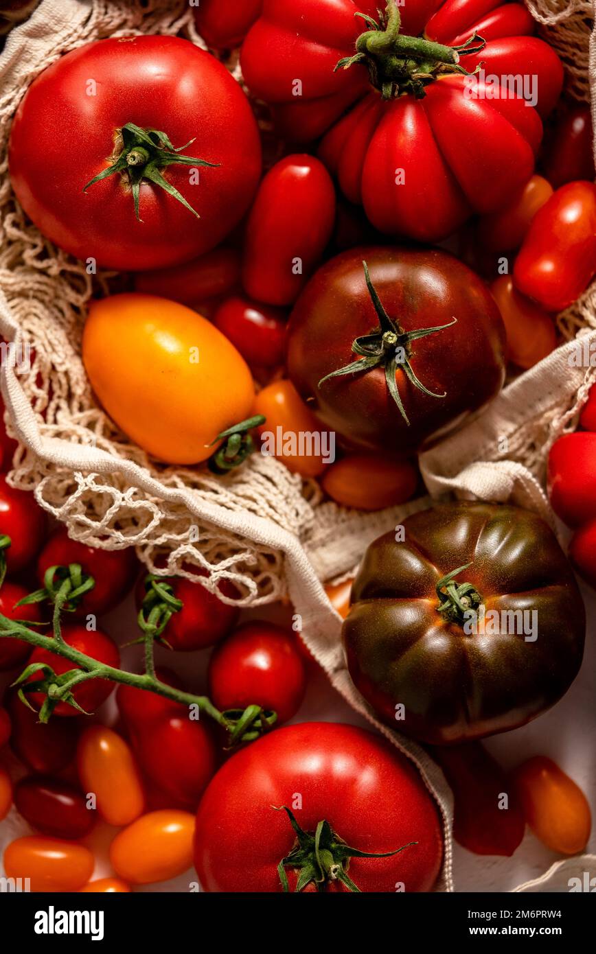 Tomatoes on the table. Tomatoes of different varieties Stock Photo - Alamy