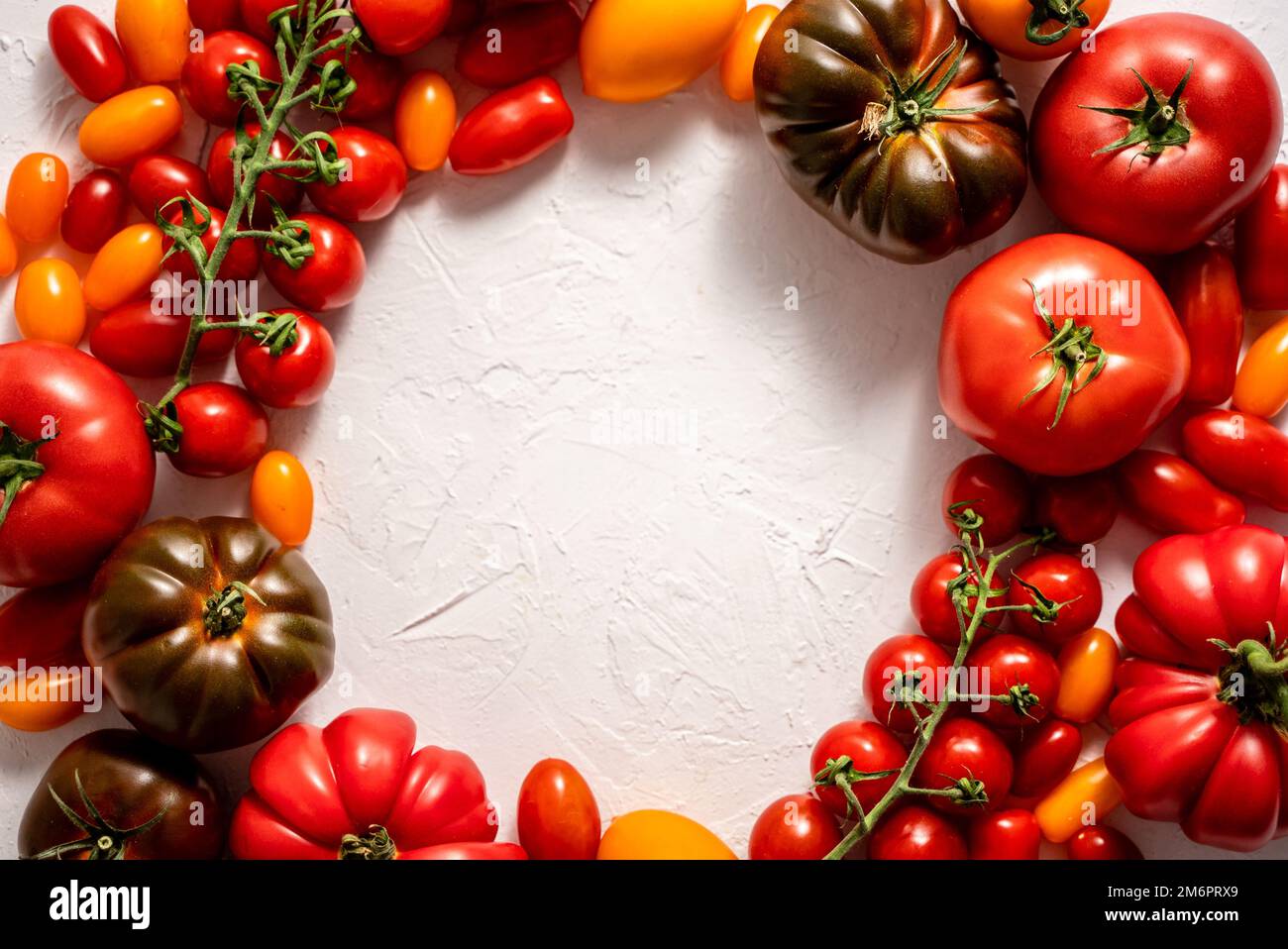 Tomatoes on the table. Tomatoes of different varieties. Circular ...