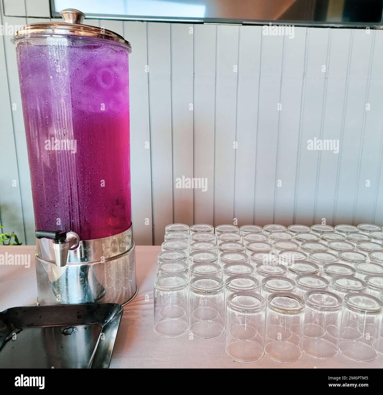 Juice drink in beverage dispenser. Self-service juice in container and ...