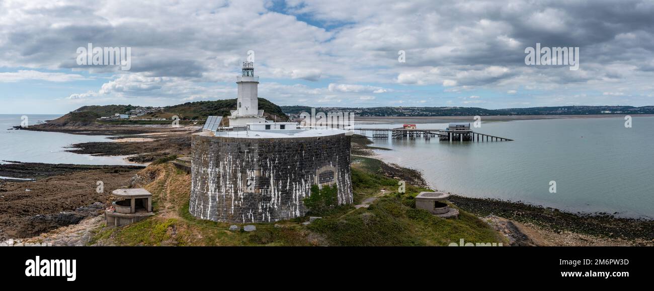View of the Mumbles headland with the historic lighthouse and piers in ...