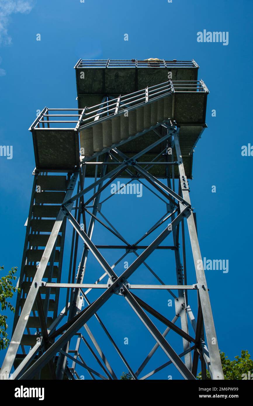 The metal tower in the forest. Blue sky background Stock Photo - Alamy