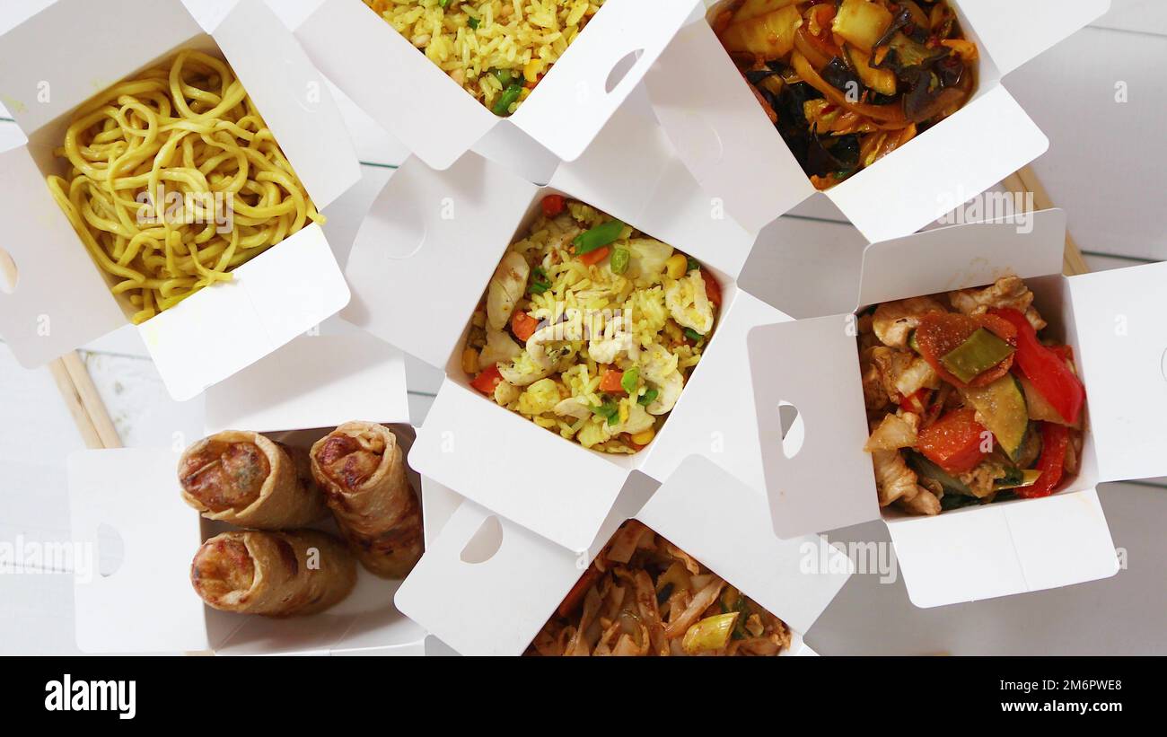Take away food concept. Spring rolls, fried rice with chicken, curry ...