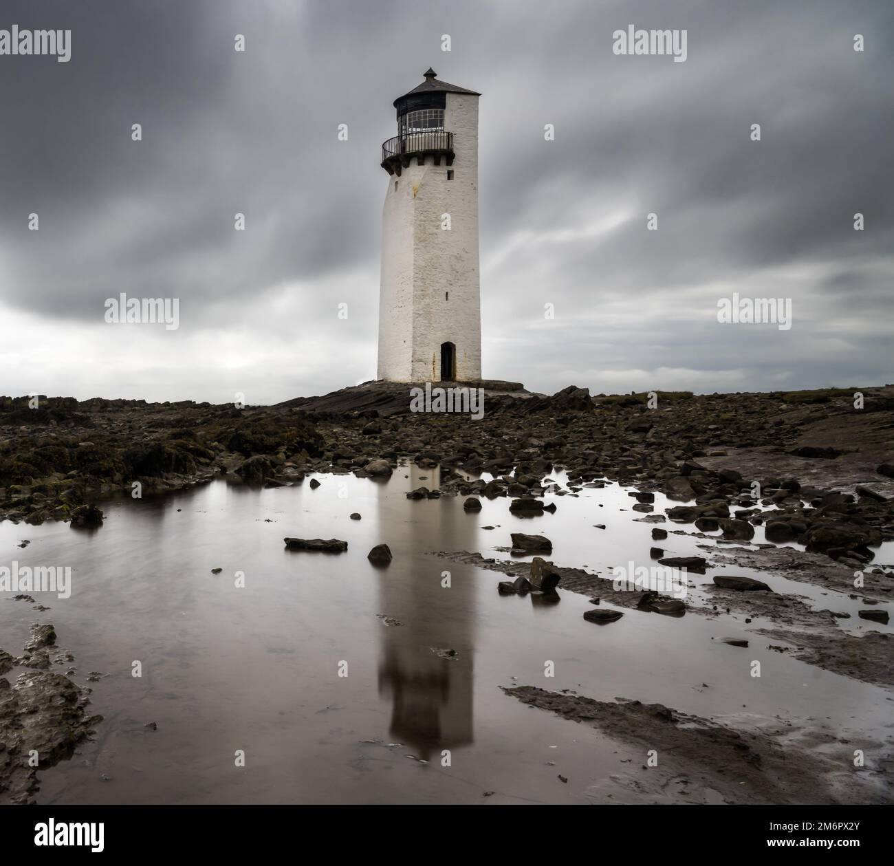 The historic Southerness Lighthouse in Scotland with reflections in ...