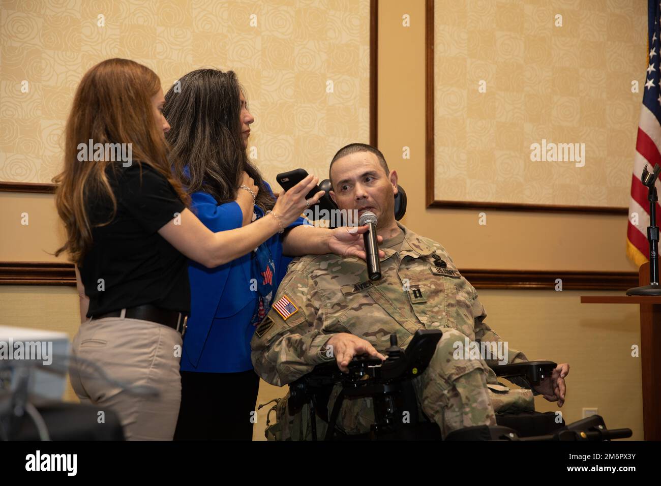 U.S. Army Cpt. Luis Avila sings the National Anthem at an opening ...