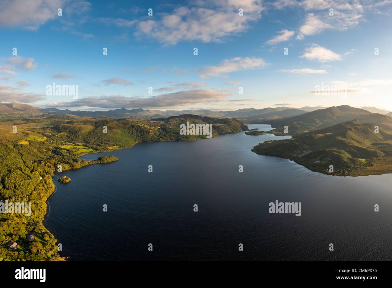 View of Lough Caragh lake in the Glencar Valley of Kerry County in warm ...