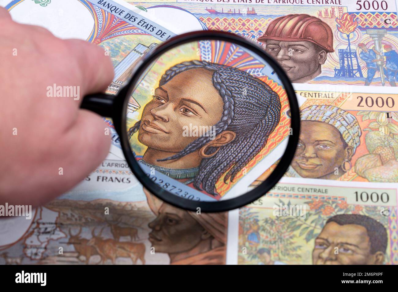 Central African money in a magnifying glass Stock Photo - Alamy