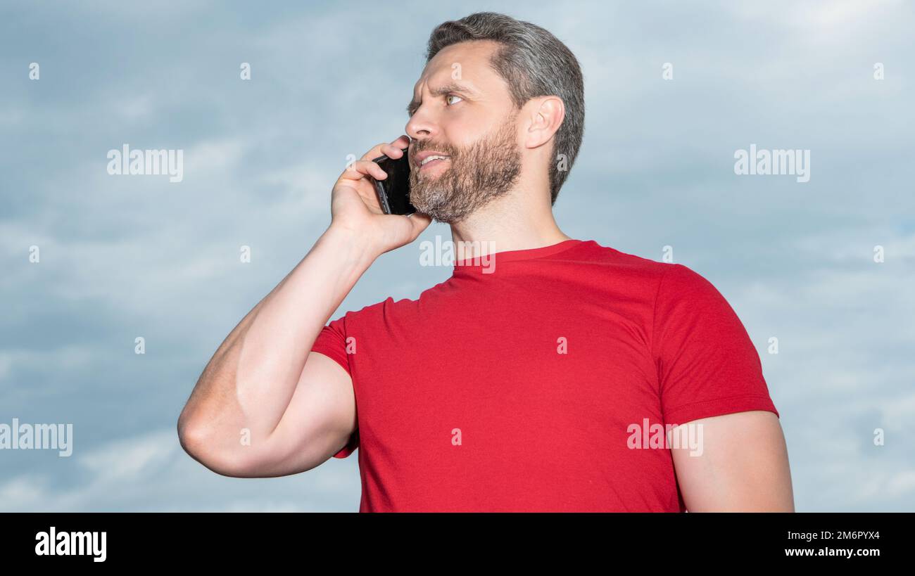 happy man has phone talk on sky background. man has phone talk outdoor ...