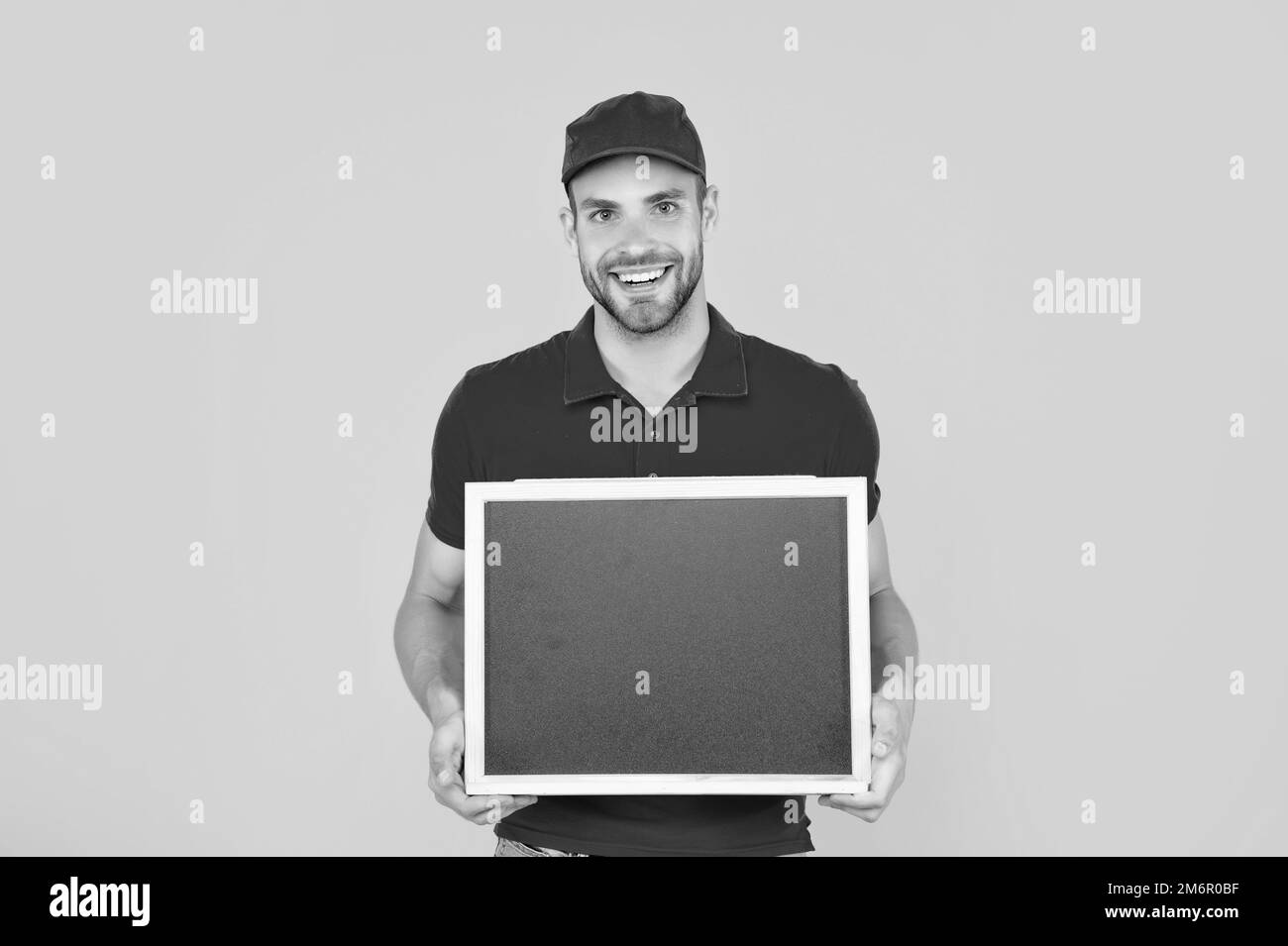 happy man in cap with blackboard. guy make announcement Stock Photo - Alamy