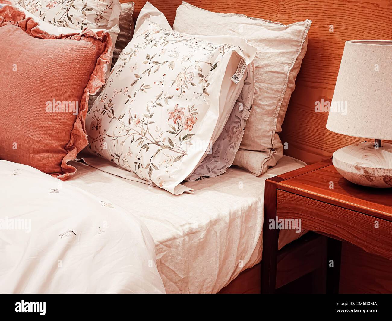 Vintage countryside style bedding with floral pattern on wooden bed in bedroom, interior design ...