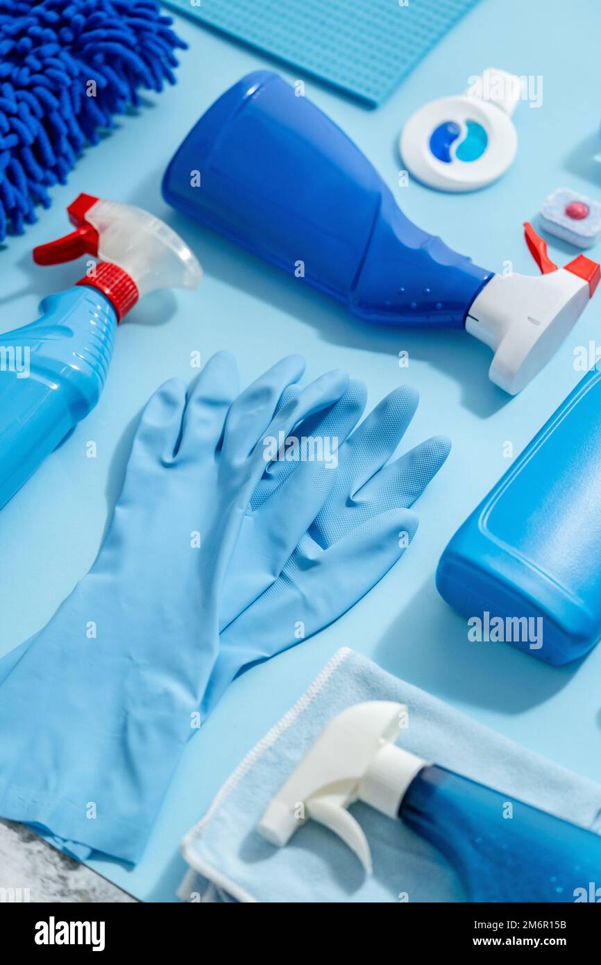 Colorful cleaning products on plain blue background. Housecleaning ...