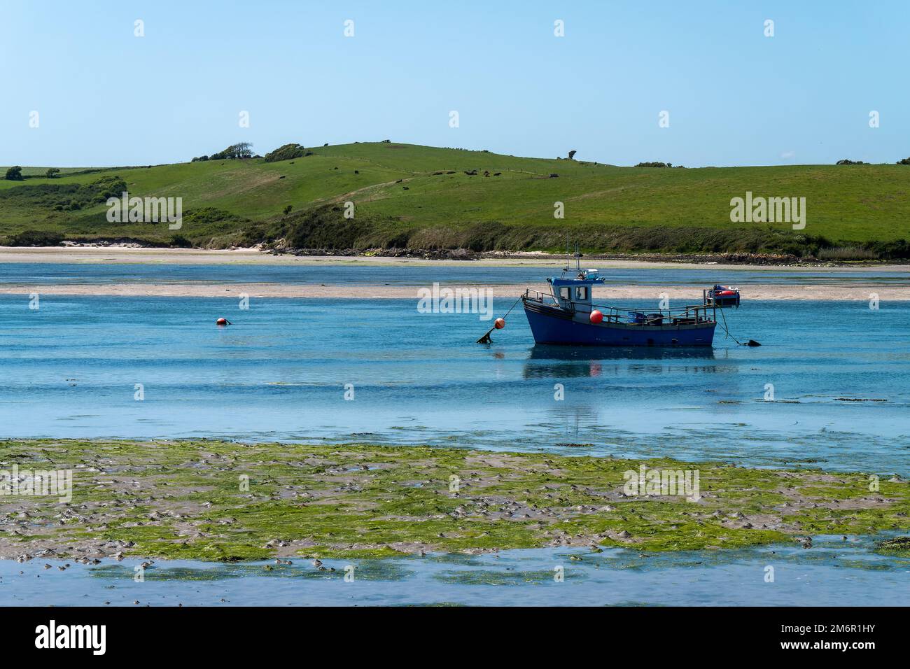 boat is anchored in the bay, low tide, a seaside landscape. A boat in ...