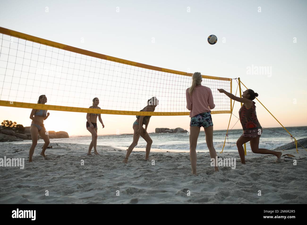 Female volleyball players playing on the beach Stock Photo - Alamy