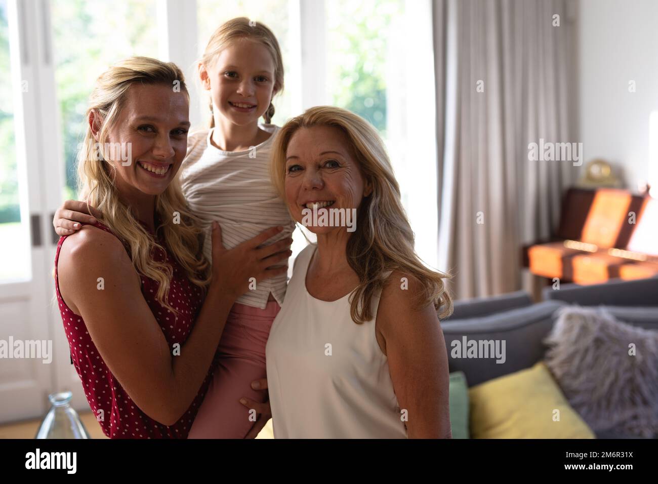 Caucasian woman with her daughter and mother at home Stock Photo - Alamy