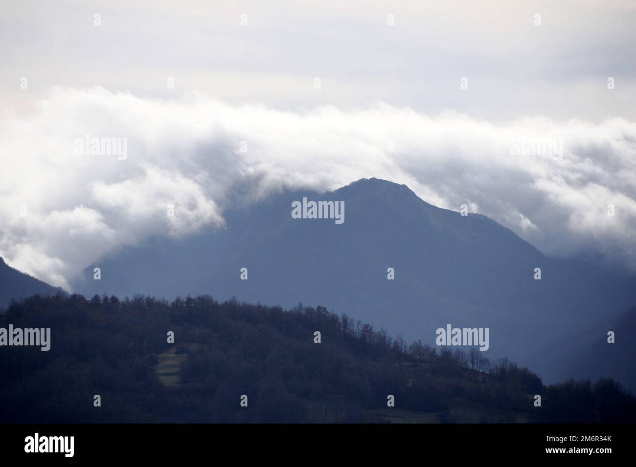 low clouds like fog in appennines valley around Bismantova stone a rock ...