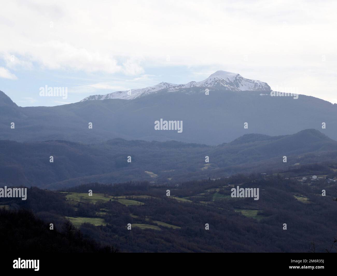 low clouds like fog in appennines valley around Bismantova stone a rock ...