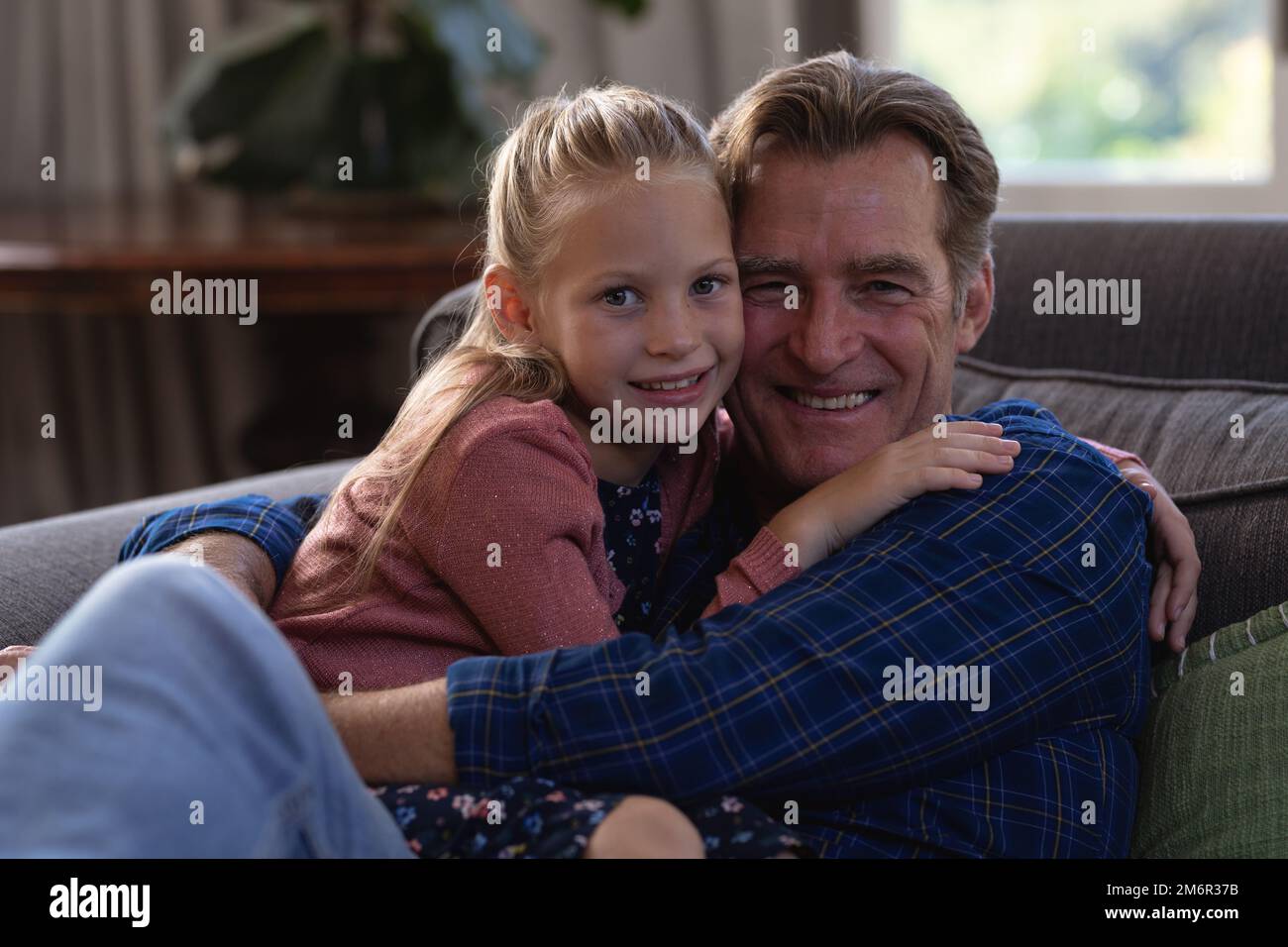 Caucasian girl and her grandfather spending time together at home ...