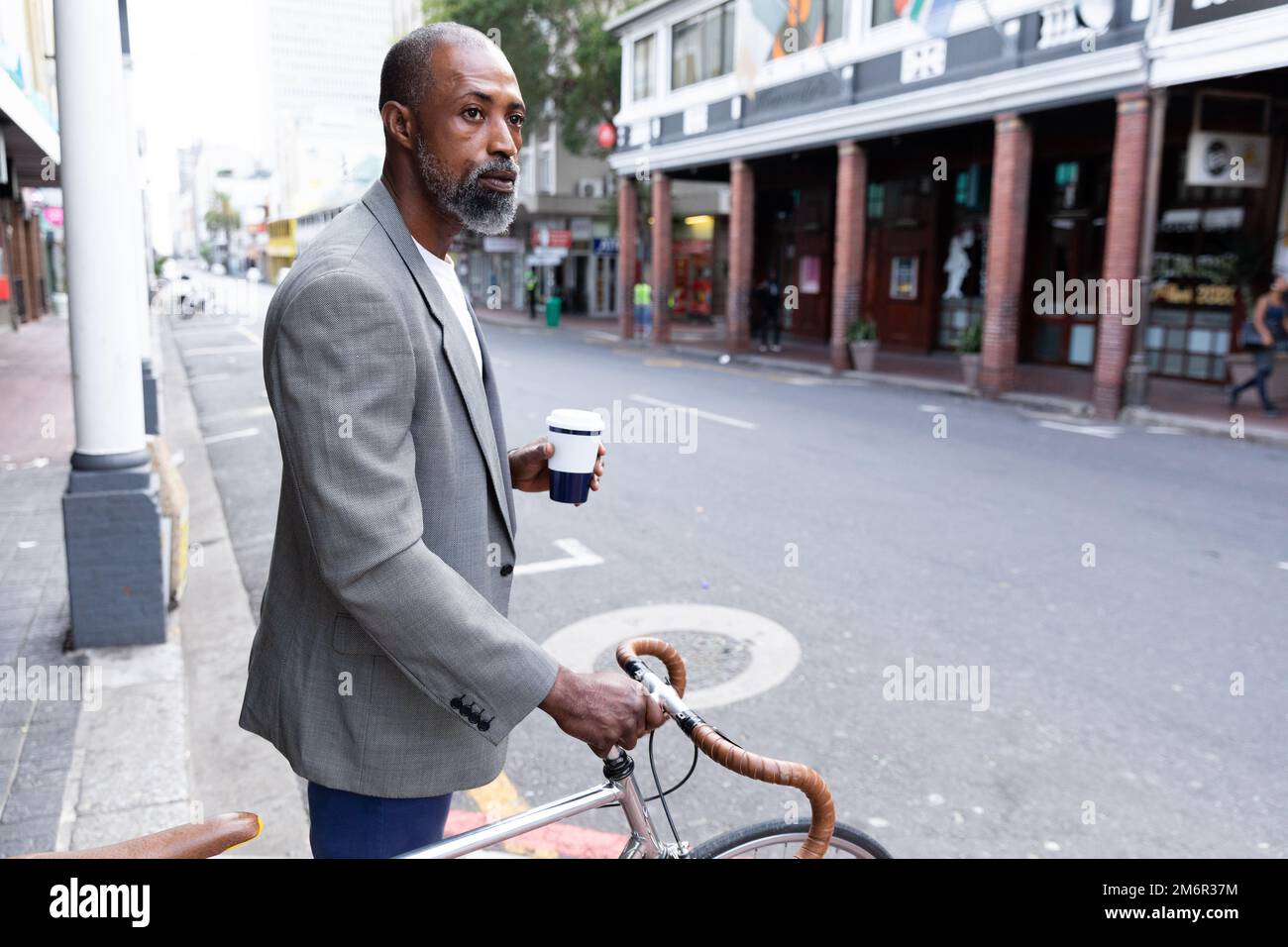 African American man riding a bike in the city street Stock Photo - Alamy