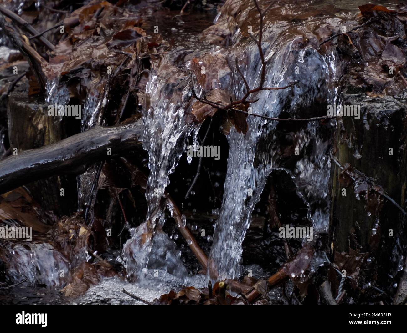 A beautiful small flowing river due to snow melt forming a clean ...