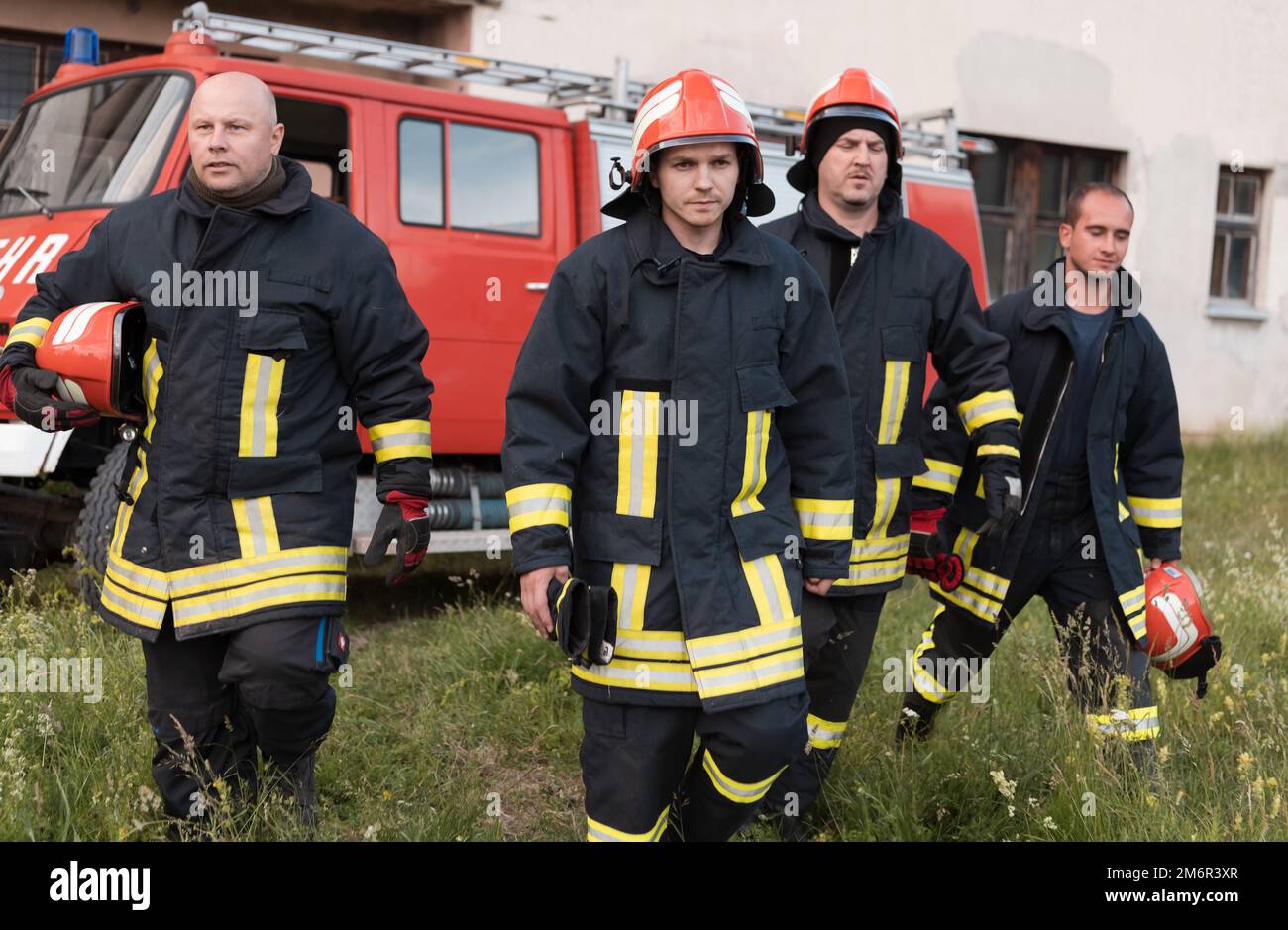 Group of fire fighters standing confident after a well done rescue ...