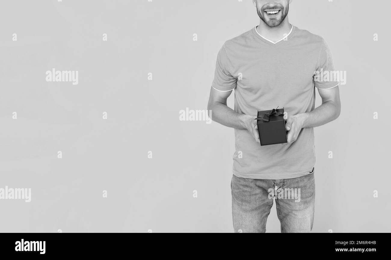 cropped guy hold gift box on yellow background with copy space, boxing ...