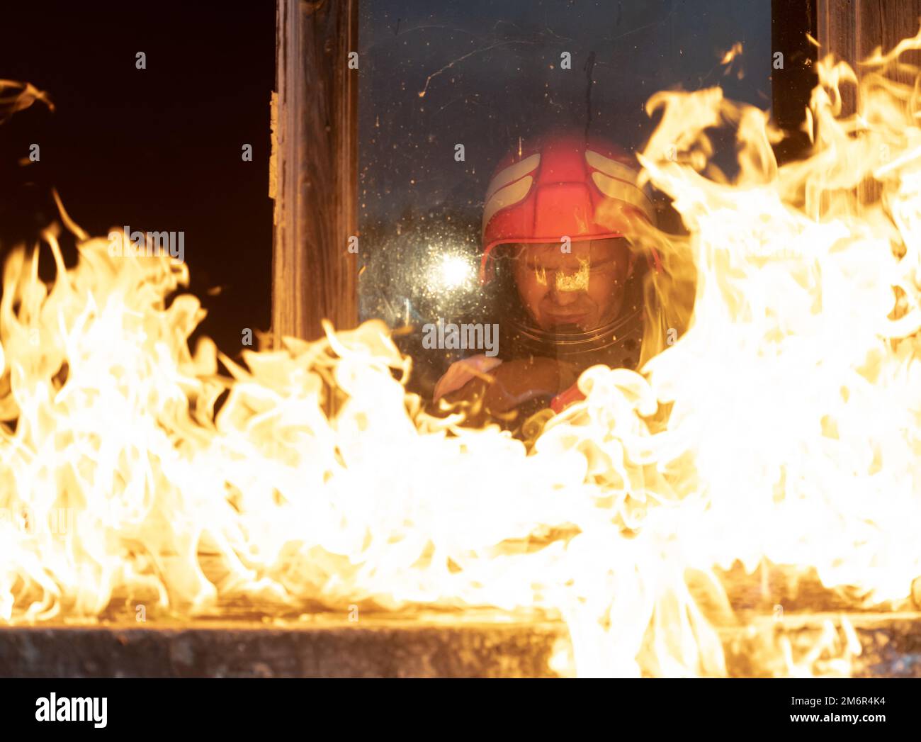 Firefighter hero carrying baby girl out from burning building area from ...