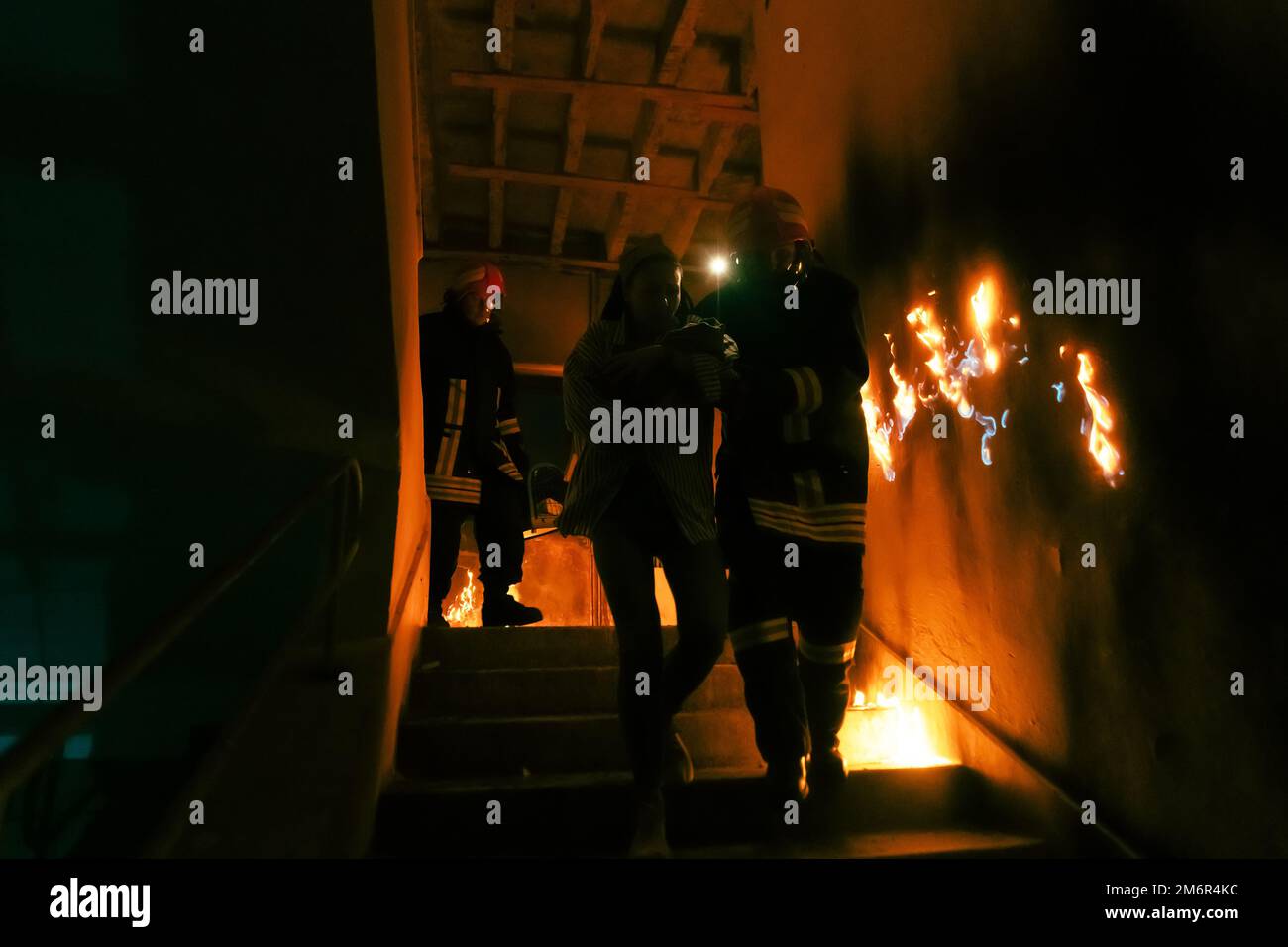 Brave Fireman Descends Stairs of a Burning Building and Holds Saved ...