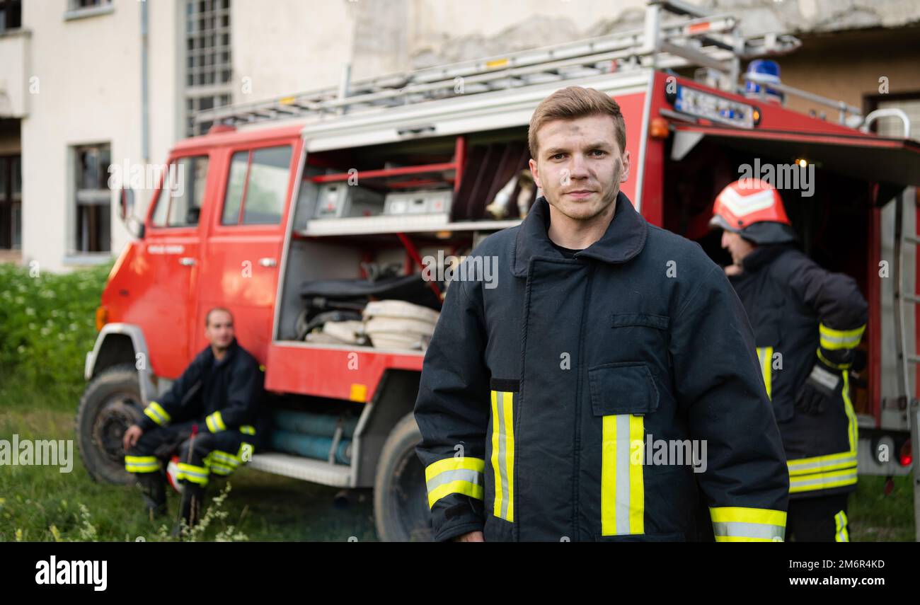 Group of fire fighters standing confident after a well done rescue ...
