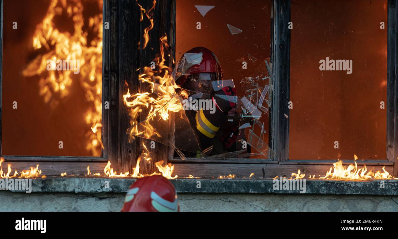 Firefighter hero carrying baby girl out from burning building area from ...