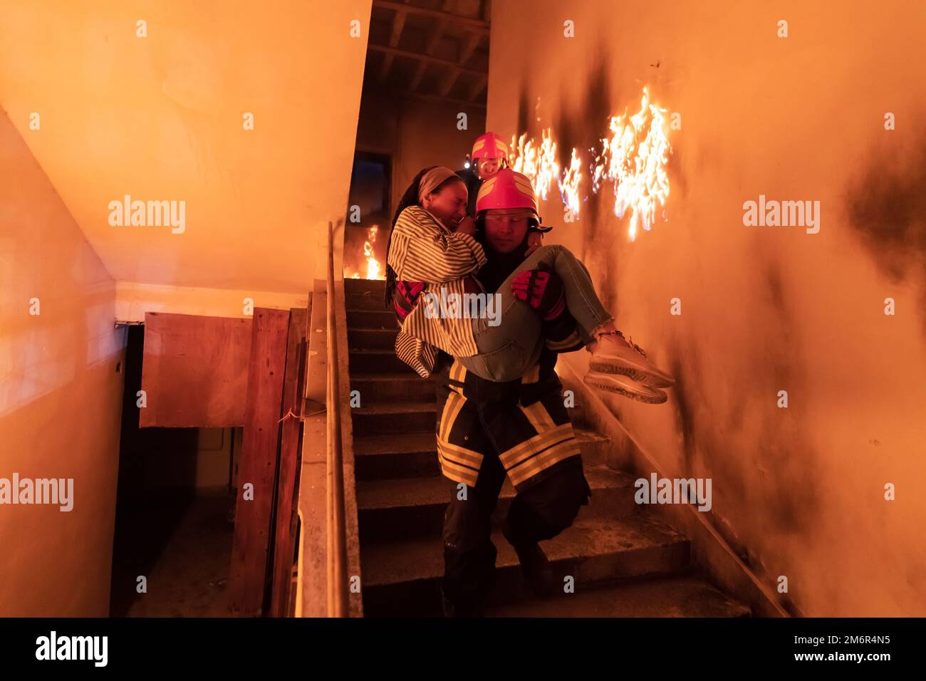Brave Fireman Descends Stairs of a Burning Building and Holds Saved ...