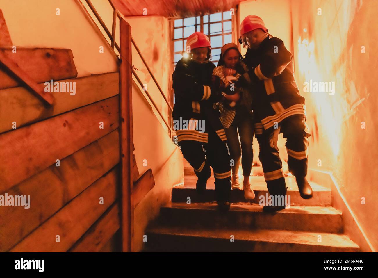 Brave Fireman Descends Stairs of a Burning Building and Holds Saved ...