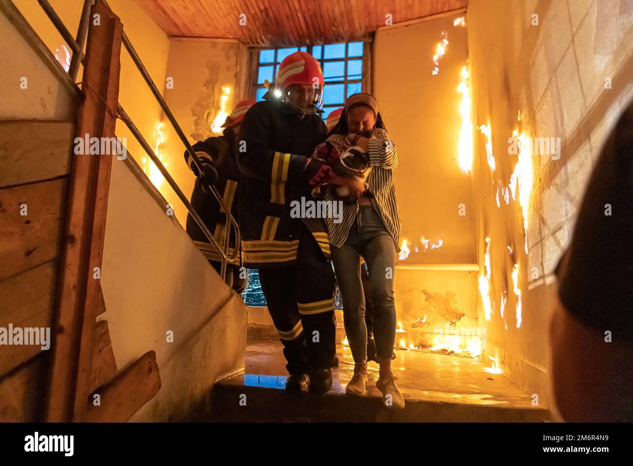 Brave Fireman Descends Stairs of a Burning Building and Holds Saved ...