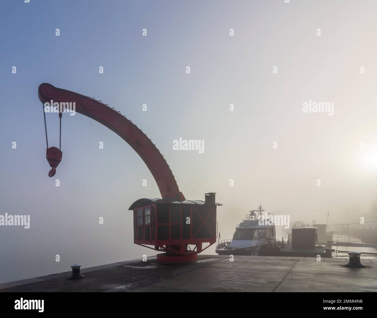 Wien, Vienna: mist at river Donau (Danube), old port crane, boat of ...